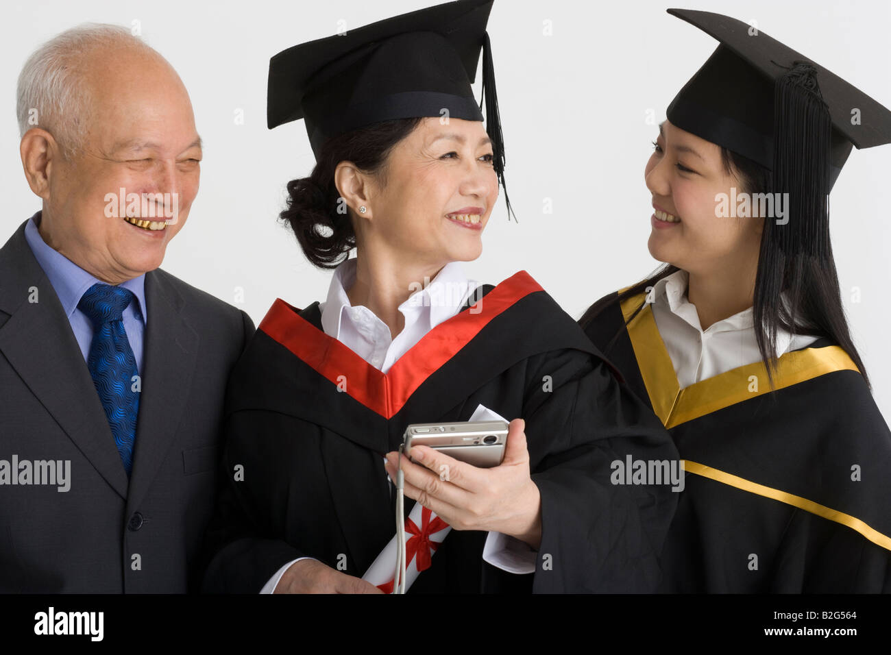 Professor with his two female university students smiling Stock Photo ...