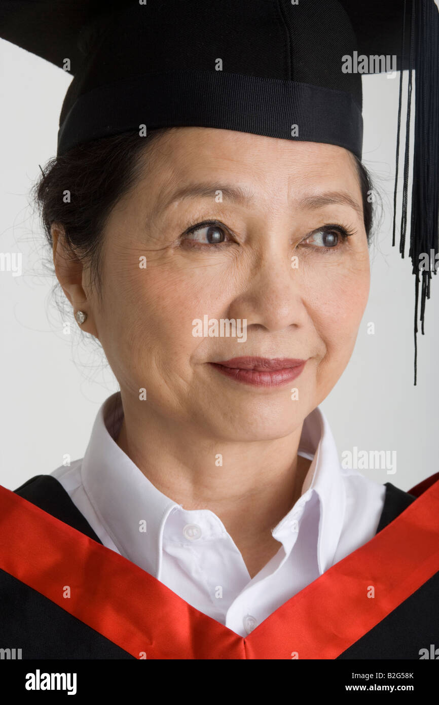 Close-up of a mature female graduate thinking and smiling Stock Photo ...