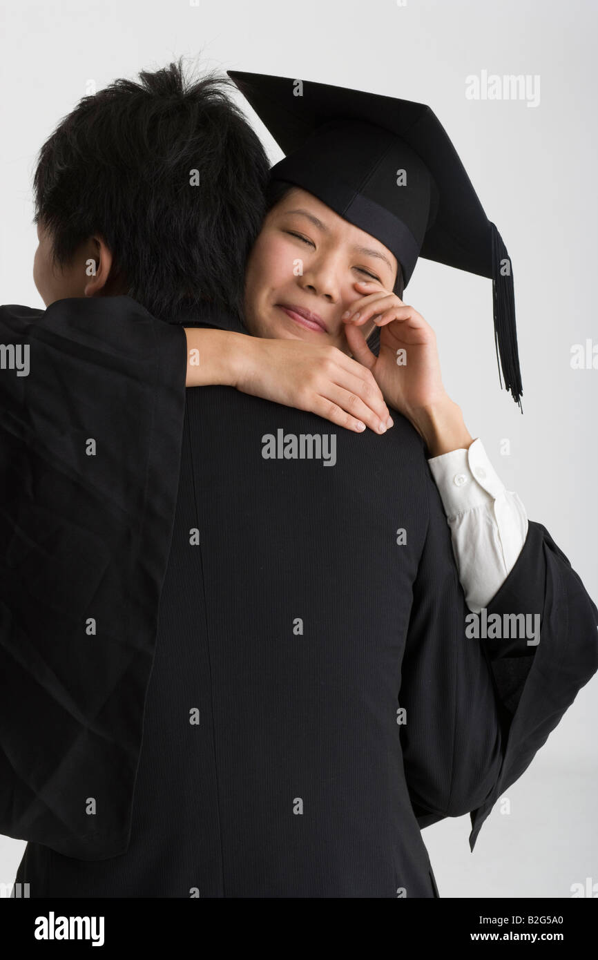 Young female graduate hugging a young man and crying Stock Photo - Alamy