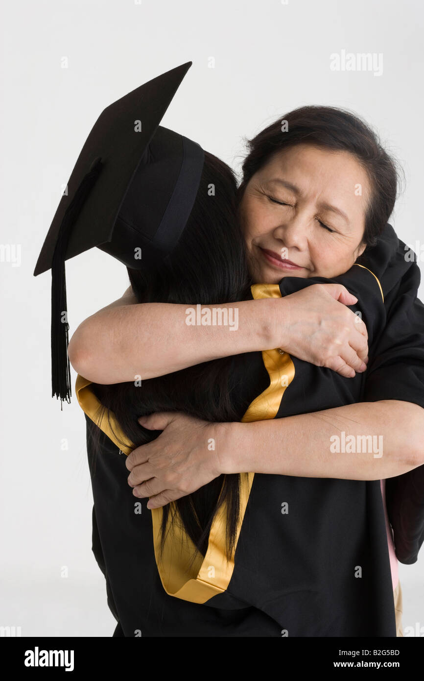 Rear view of a young female graduate hugging her mother Stock Photo - Alamy