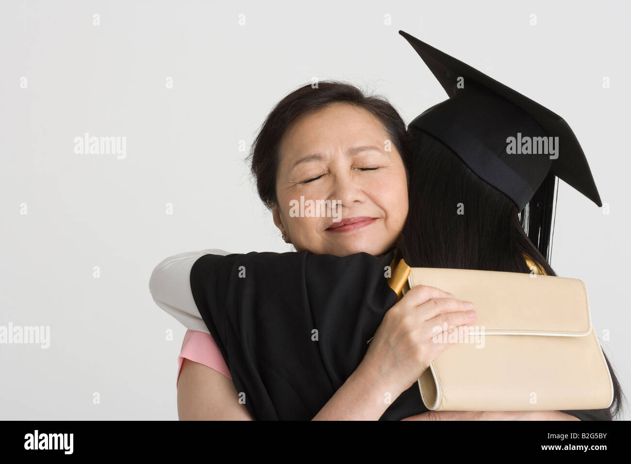 Rear view of a young female graduate hugging her mother Stock Photo - Alamy