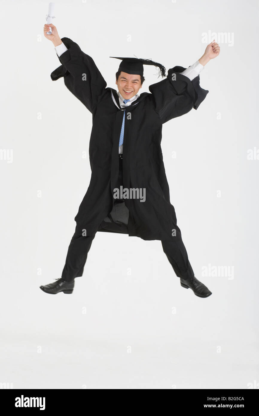 Graduate jumping into air hi-res stock photography and images - Alamy