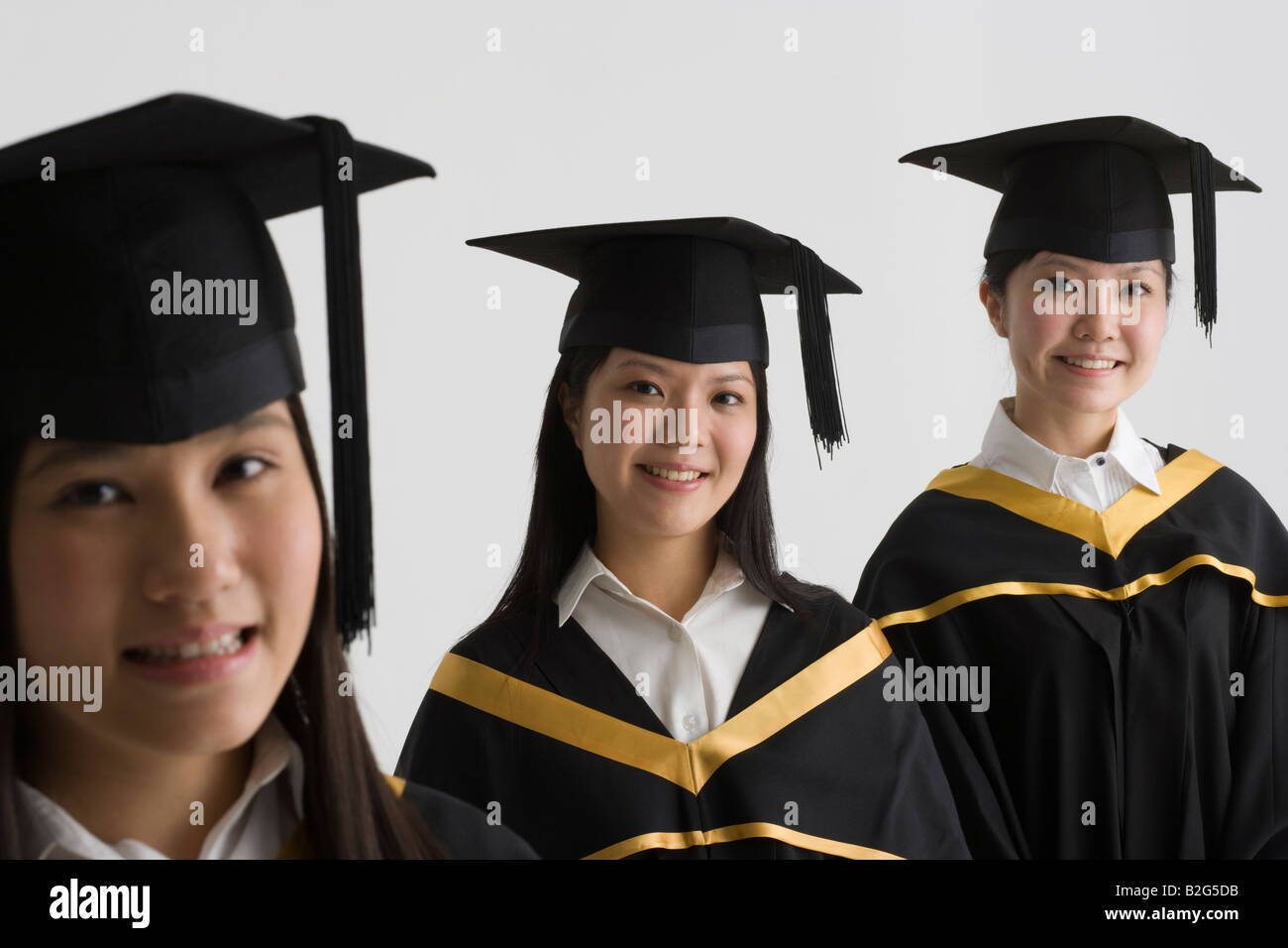 Portrait of three young female graduates smiling Stock Photo - Alamy