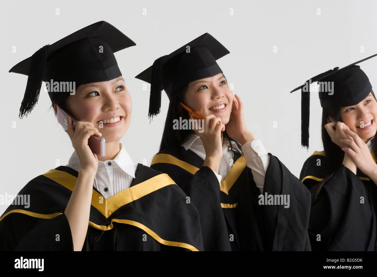 Three students looking listening hi-res stock photography and images ...