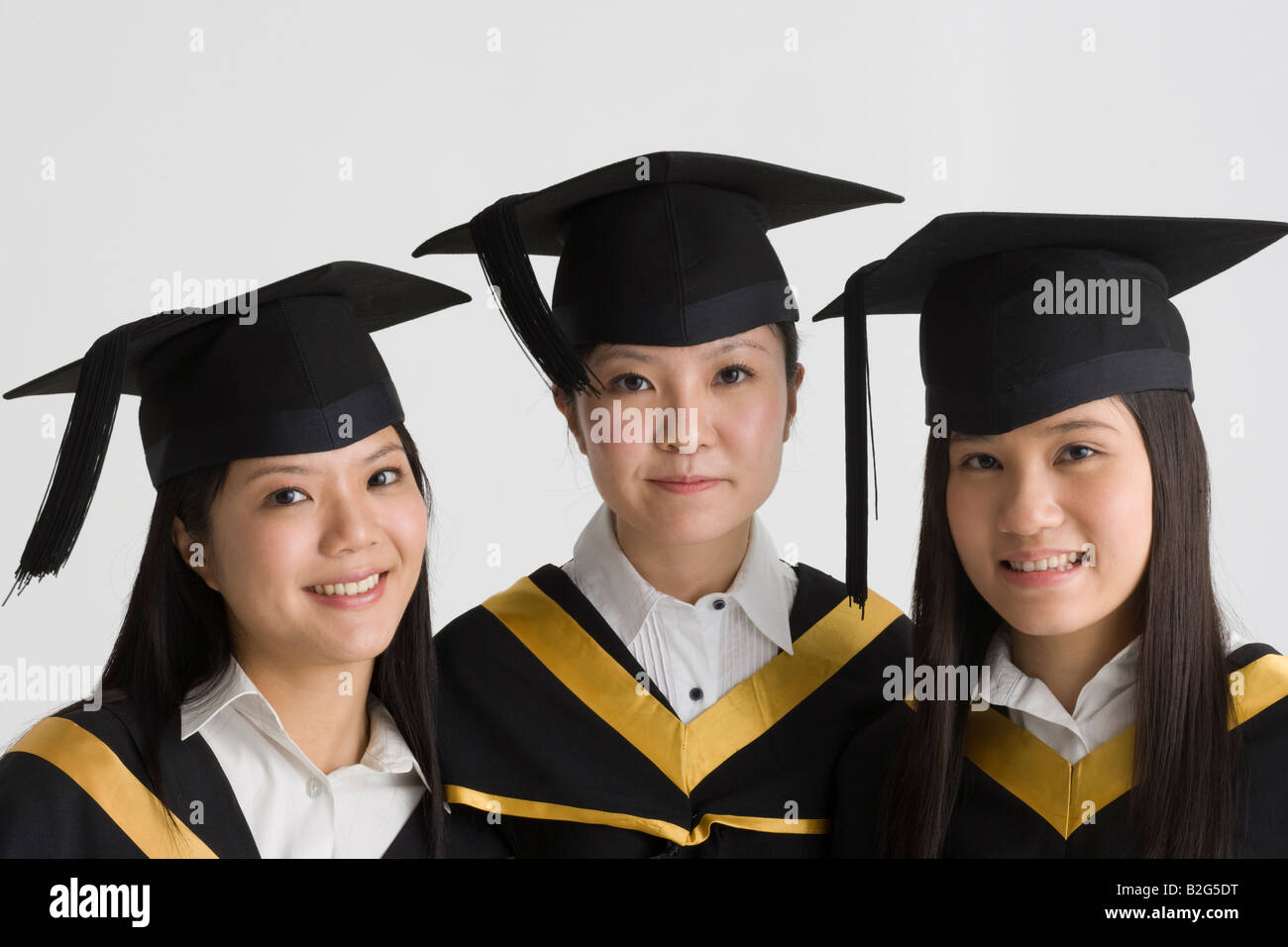 Portrait of three female graduate students smiling together Stock Photo ...