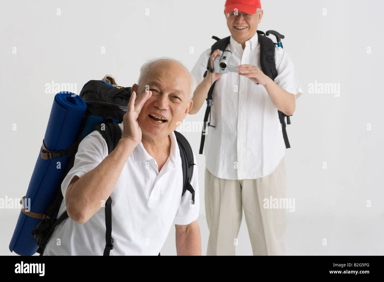 Senior man shouting and his friend filming in the background Stock ...