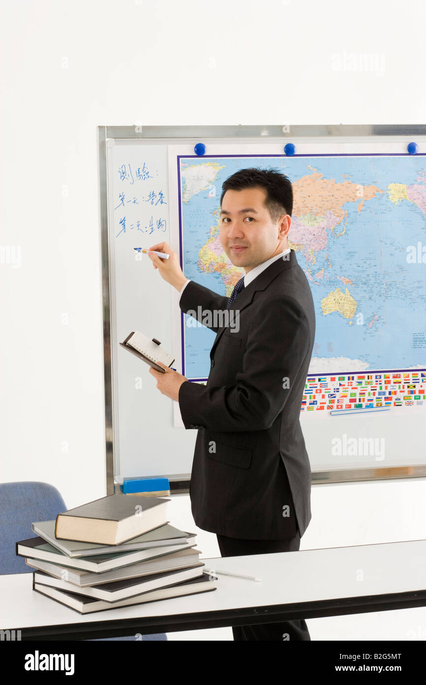 Portrait of a professor writing on a whiteboard Stock Photo - Alamy
