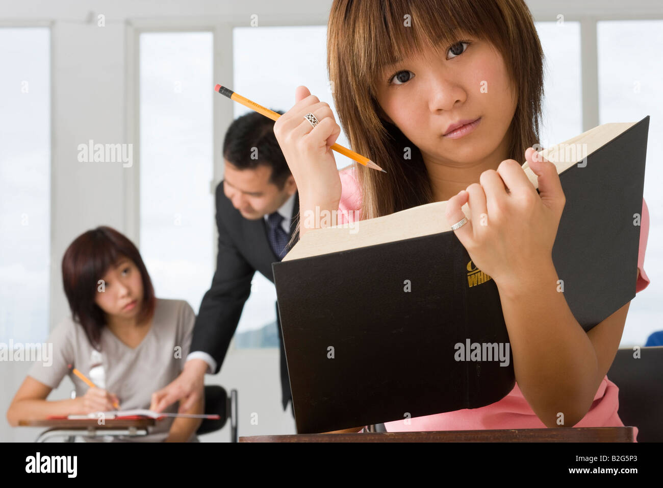 Portrait of a young woman studying in a classroom Stock Photo - Alamy
