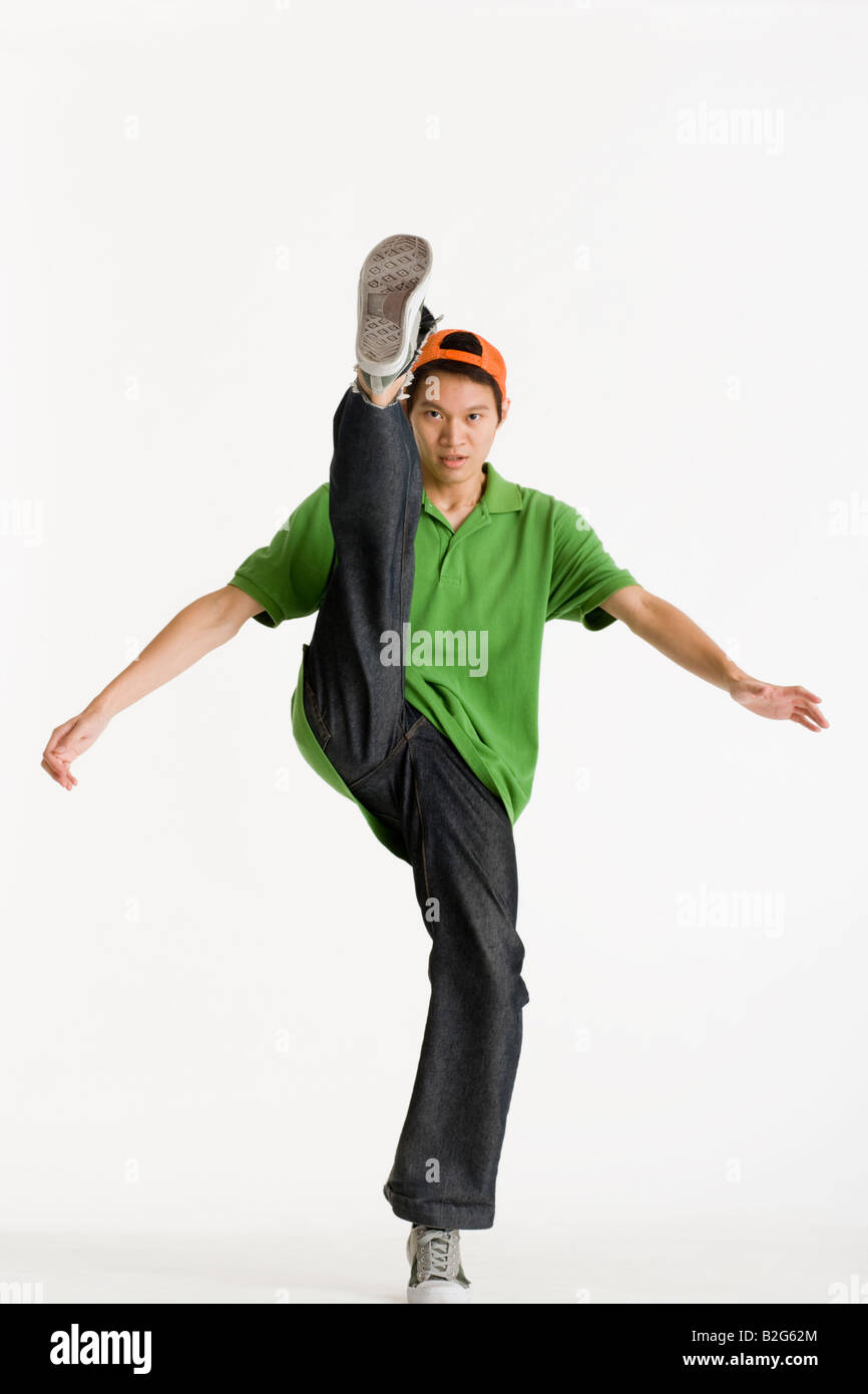 Portrait of a young man kicking Stock Photo - Alamy