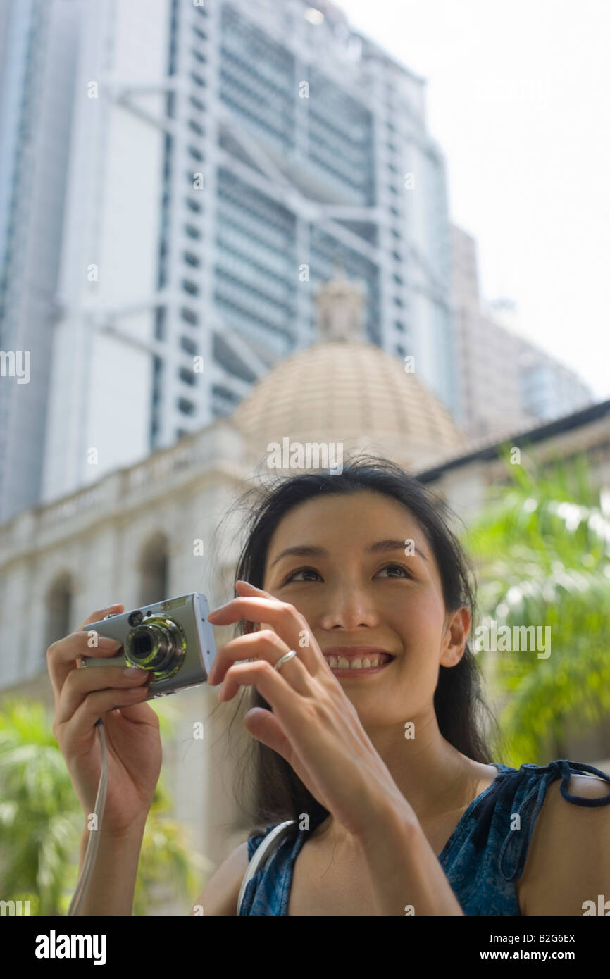 Young woman photographing with a digital camera Stock Photo - Alamy