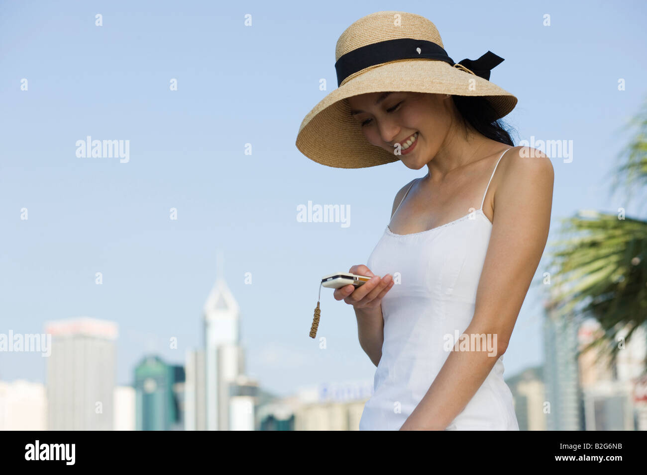 Young woman text messaging and smiling Stock Photo - Alamy