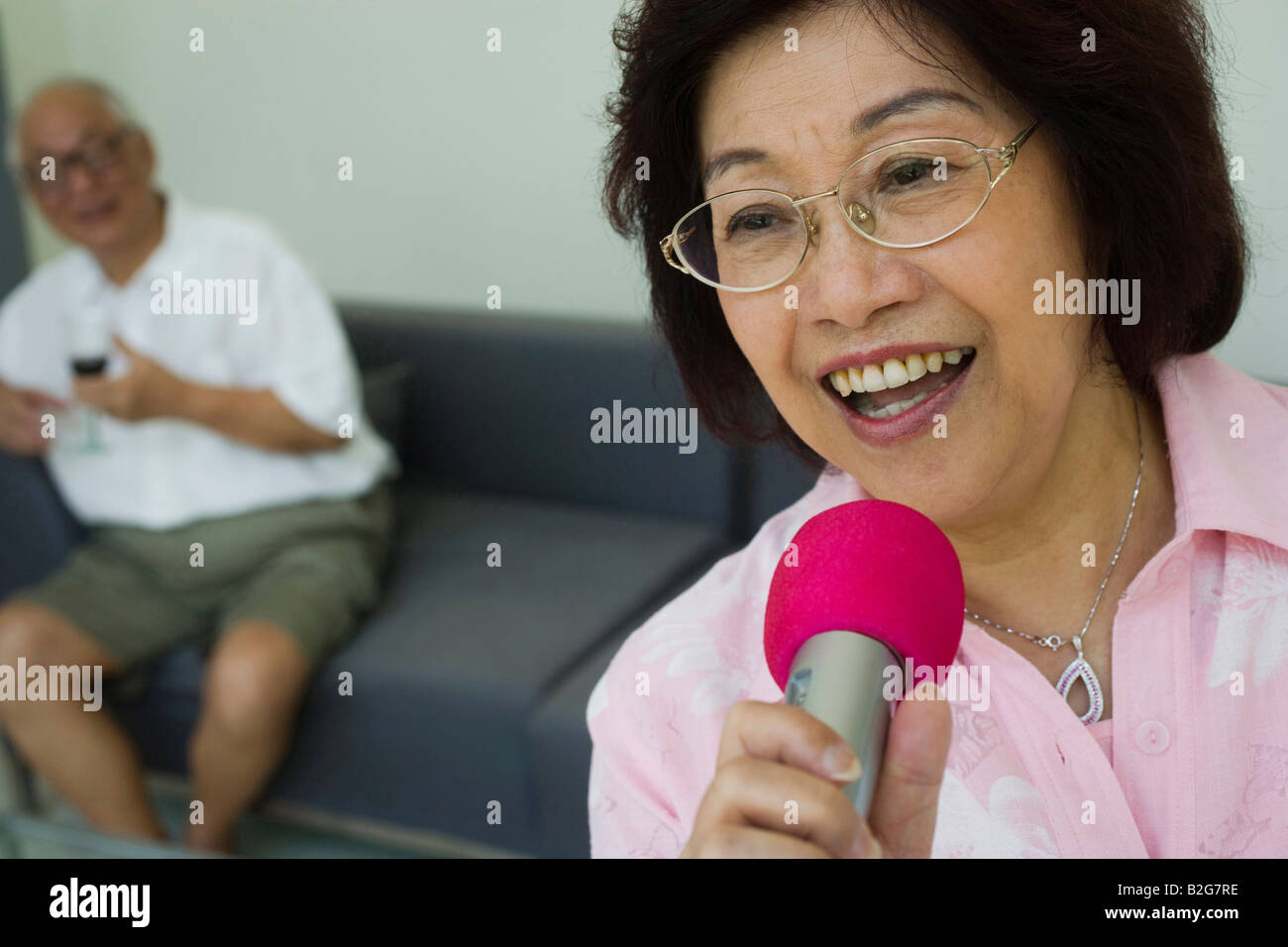 Asian woman microphone singing hi-res stock photography and images - Alamy