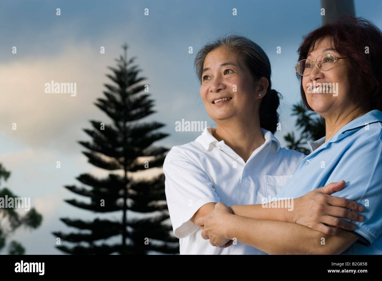 Two senior women hugging each other and smiling Stock Photo - Alamy