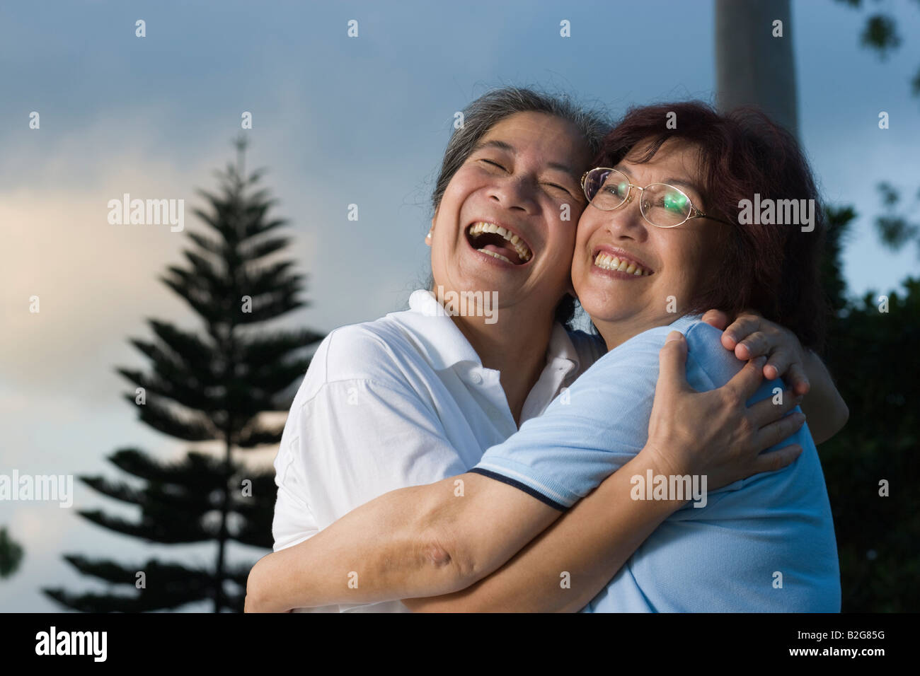 Two senior women hugging each other and smiling Stock Photo - Alamy