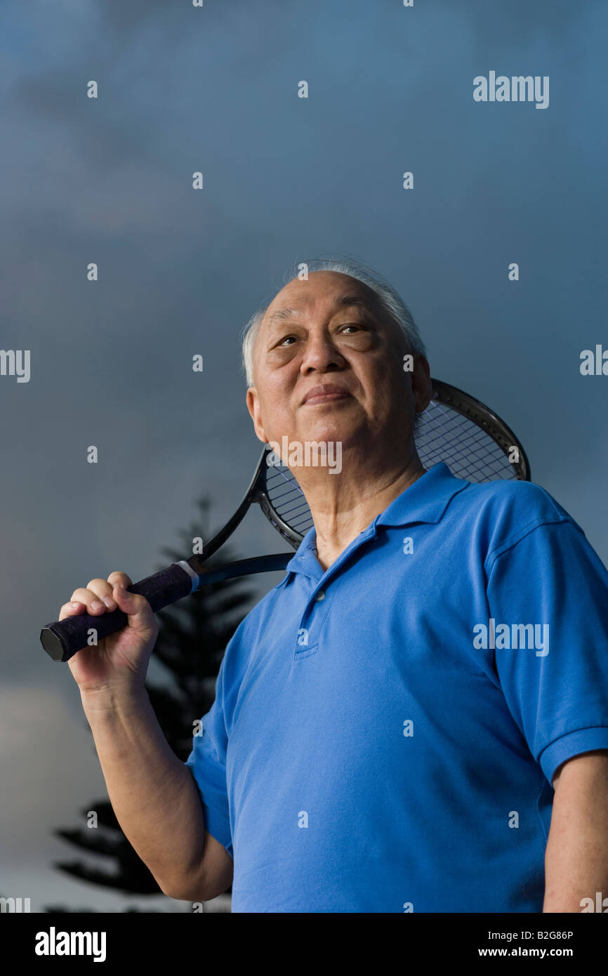 Low angle view of a senior man holding a tennis racket Stock Photo - Alamy