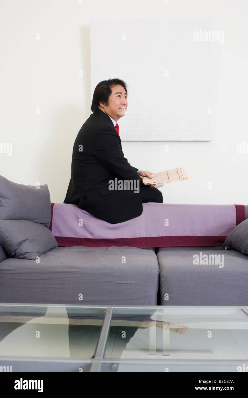 Side profile of a businessman sitting on a couch and thinking Stock ...