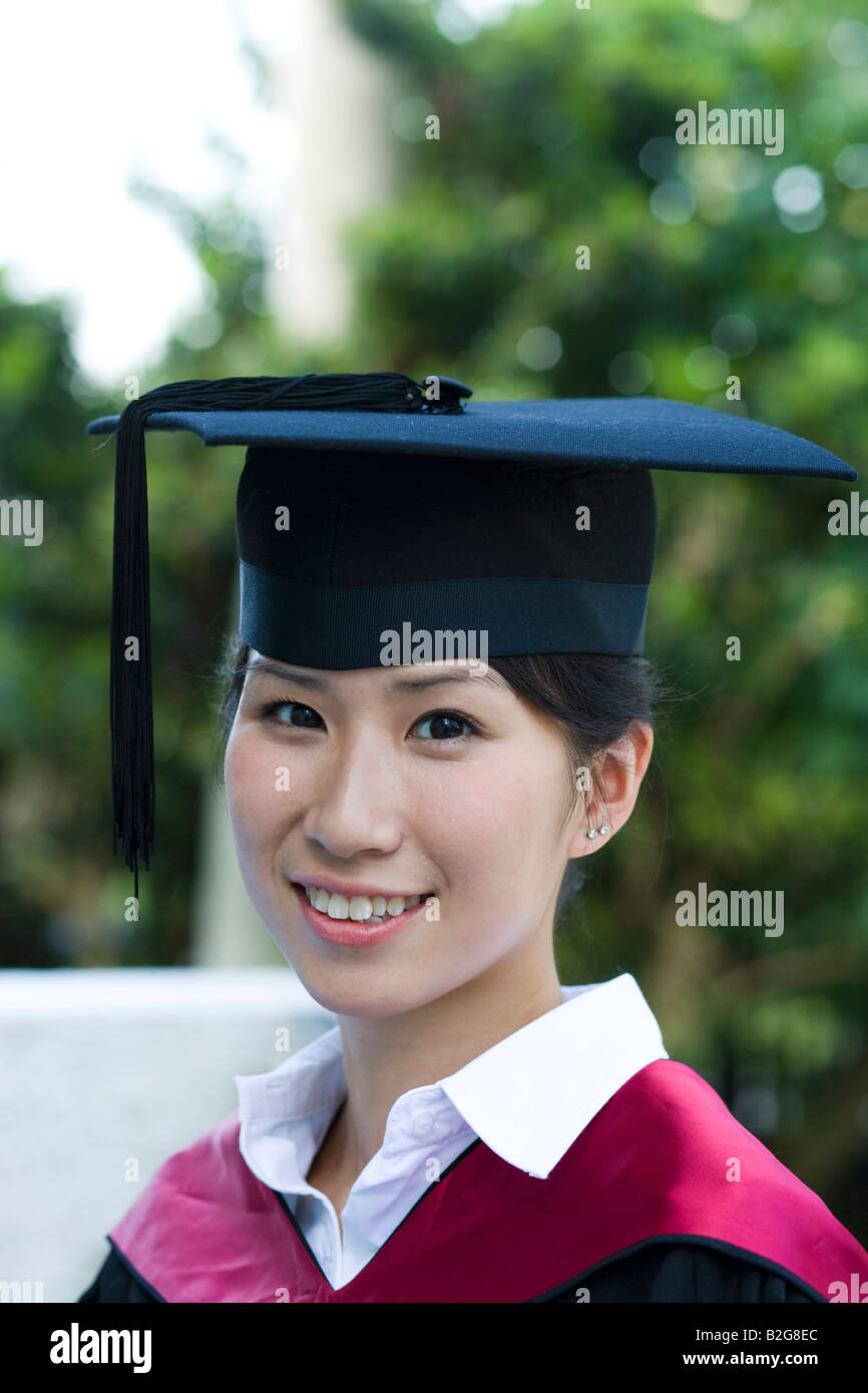 Portrait of a young female graduate smiling Stock Photo - Alamy