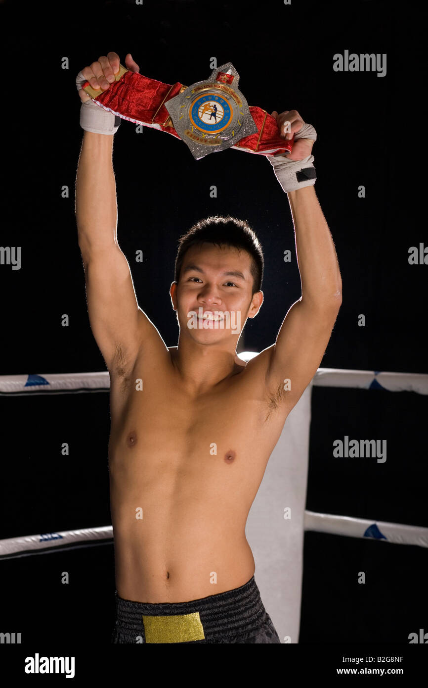 Young man holding up a championship belt Stock Photo - Alamy