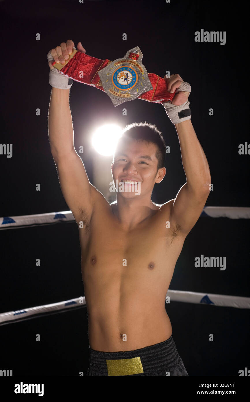 Young man holding a championship belt in a boxing ring Stock Photo - Alamy