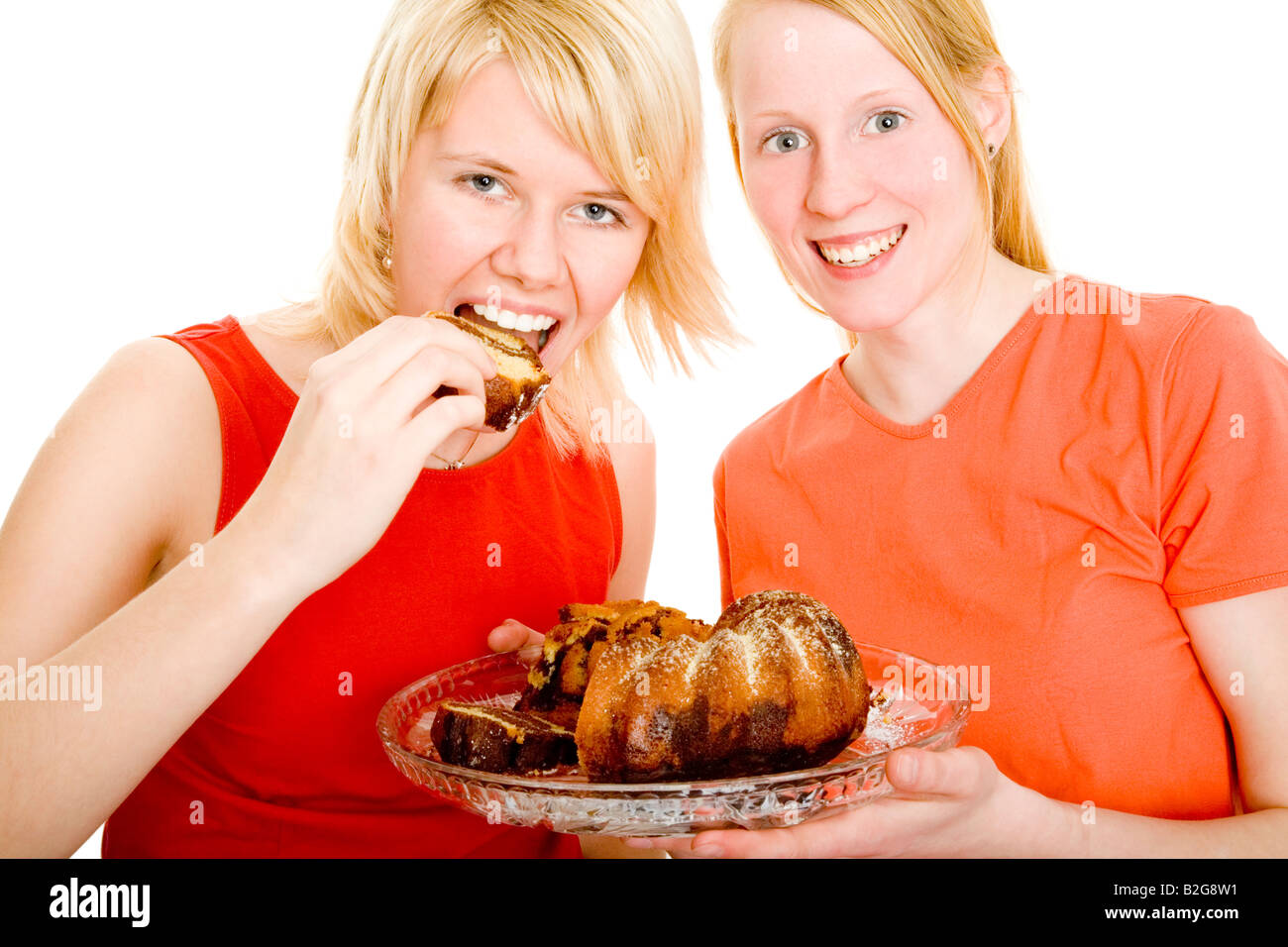 pair couple blond women eating marble cake Stock Photo - Alamy