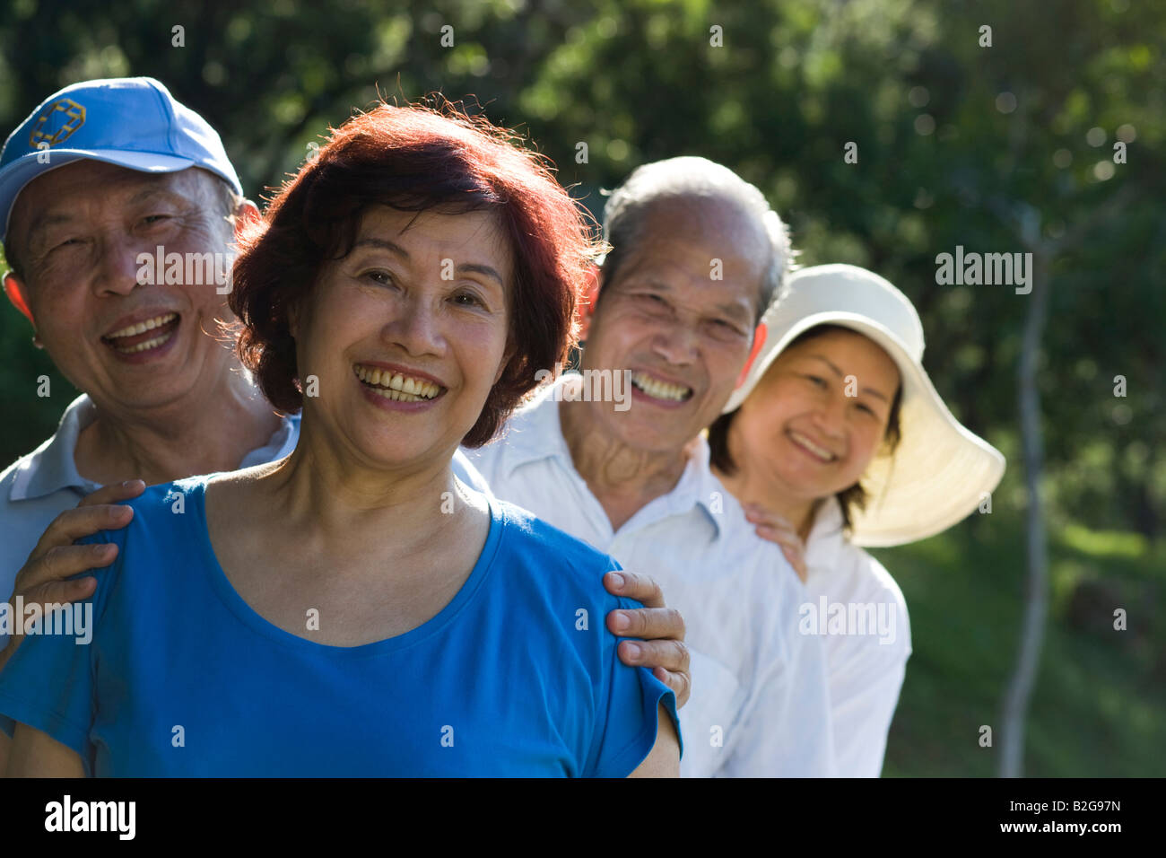 Portrait of two couples smiling in a row Stock Photo - Alamy