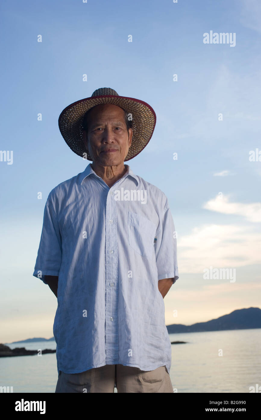 Portrait of a senior man standing at the seaside Stock Photo - Alamy