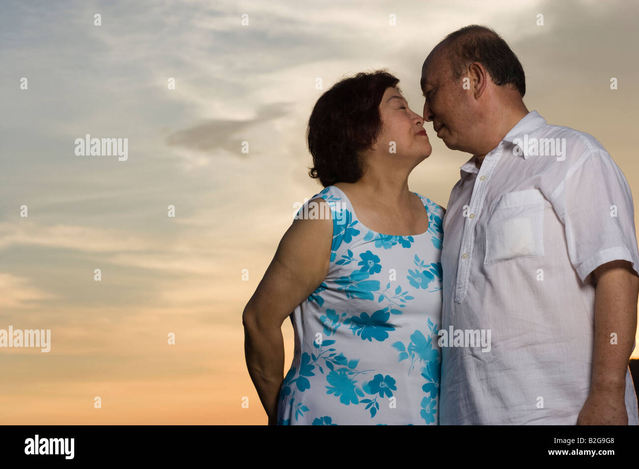 Low angle view of a couple nuzzling Stock Photo - Alamy