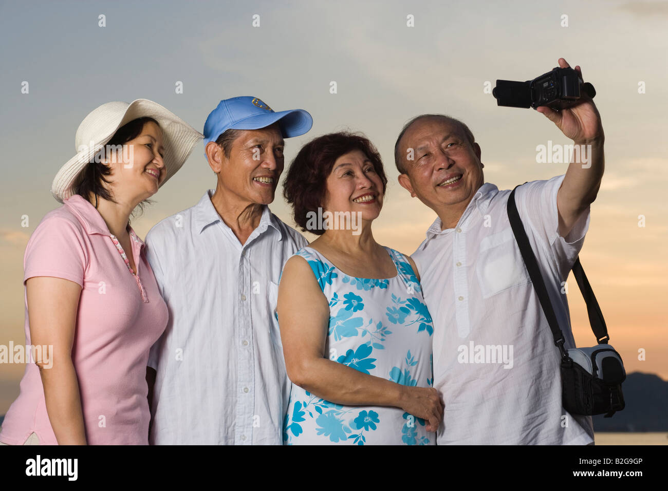 Two couples filming themselves with a home video camera Stock Photo - Alamy