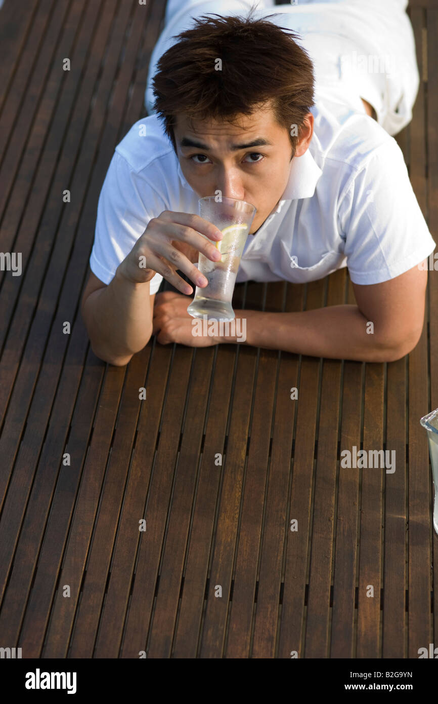 Portrait of a young man drinking lemonade Stock Photo - Alamy
