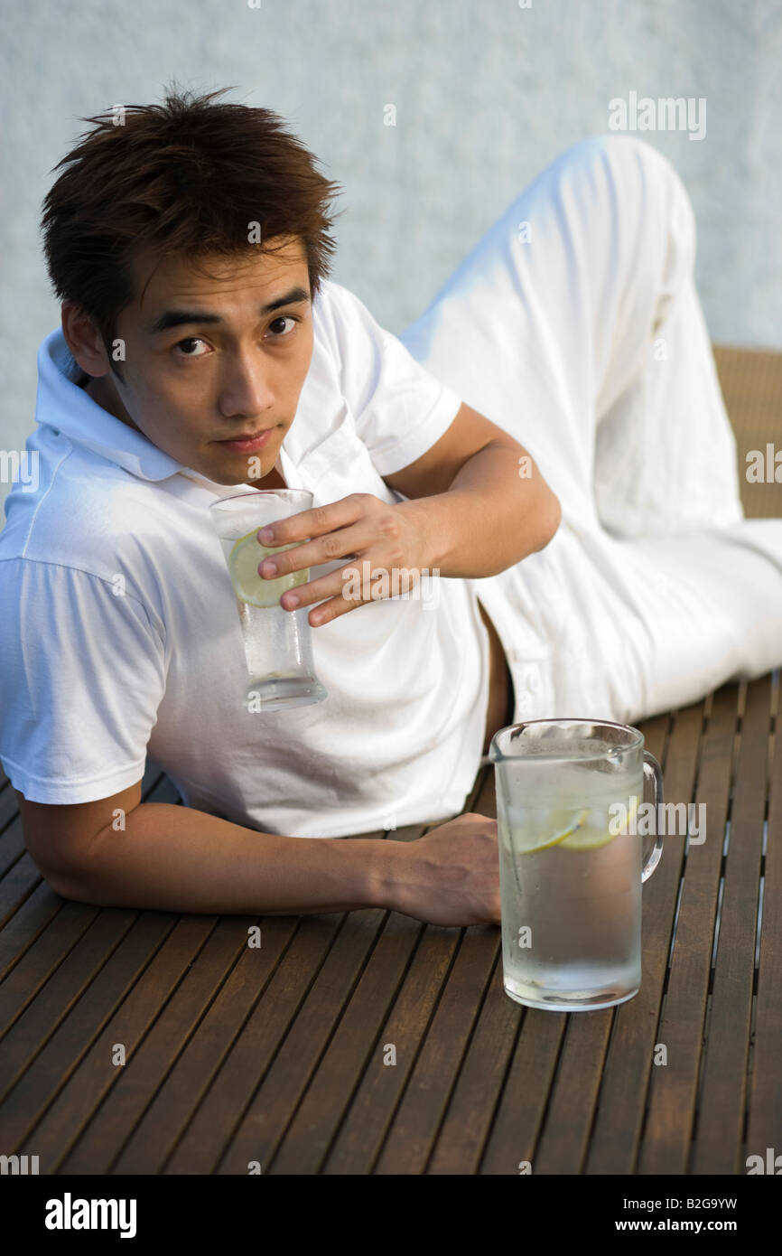 Portrait of a young man drinking lemonade Stock Photo - Alamy