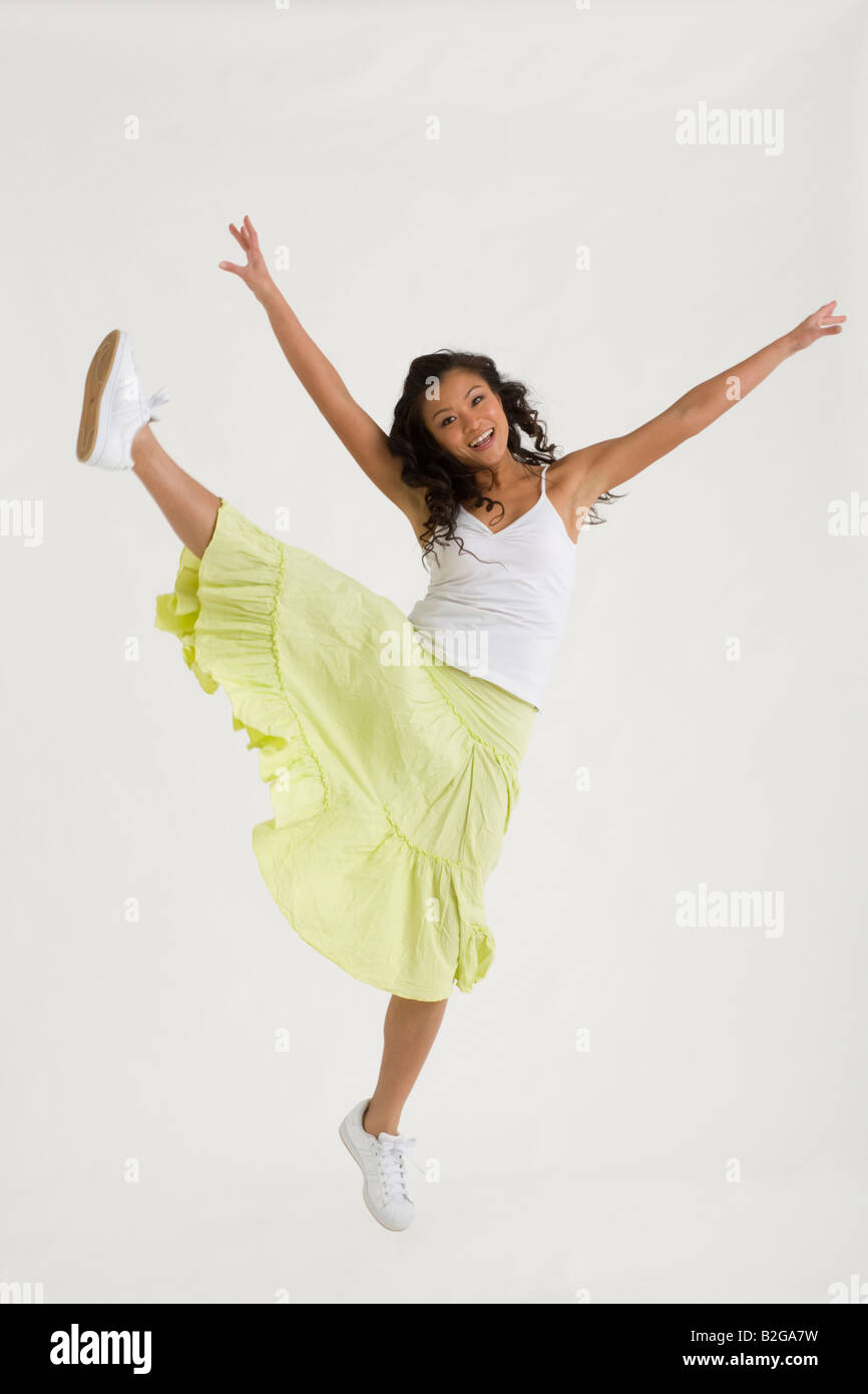 Portrait of a young woman dancing and smiling Stock Photo - Alamy