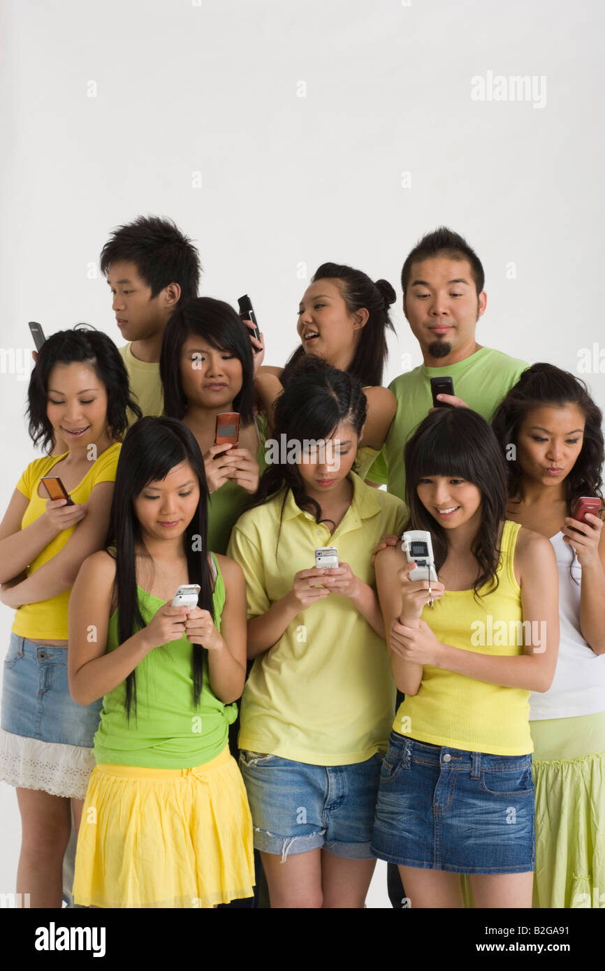 Group of friends text messaging Stock Photo - Alamy