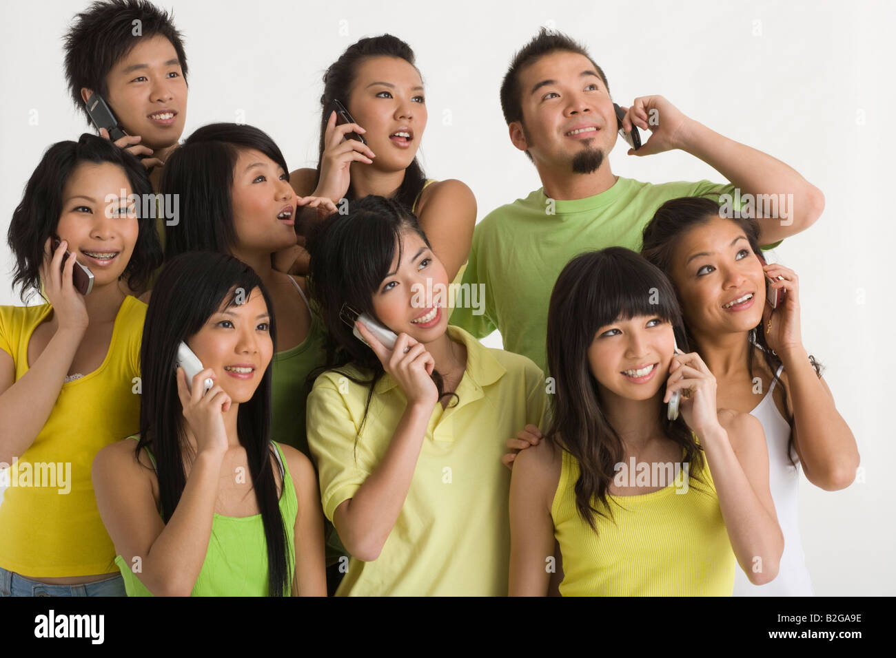 Group of friends talking on mobile phones Stock Photo - Alamy