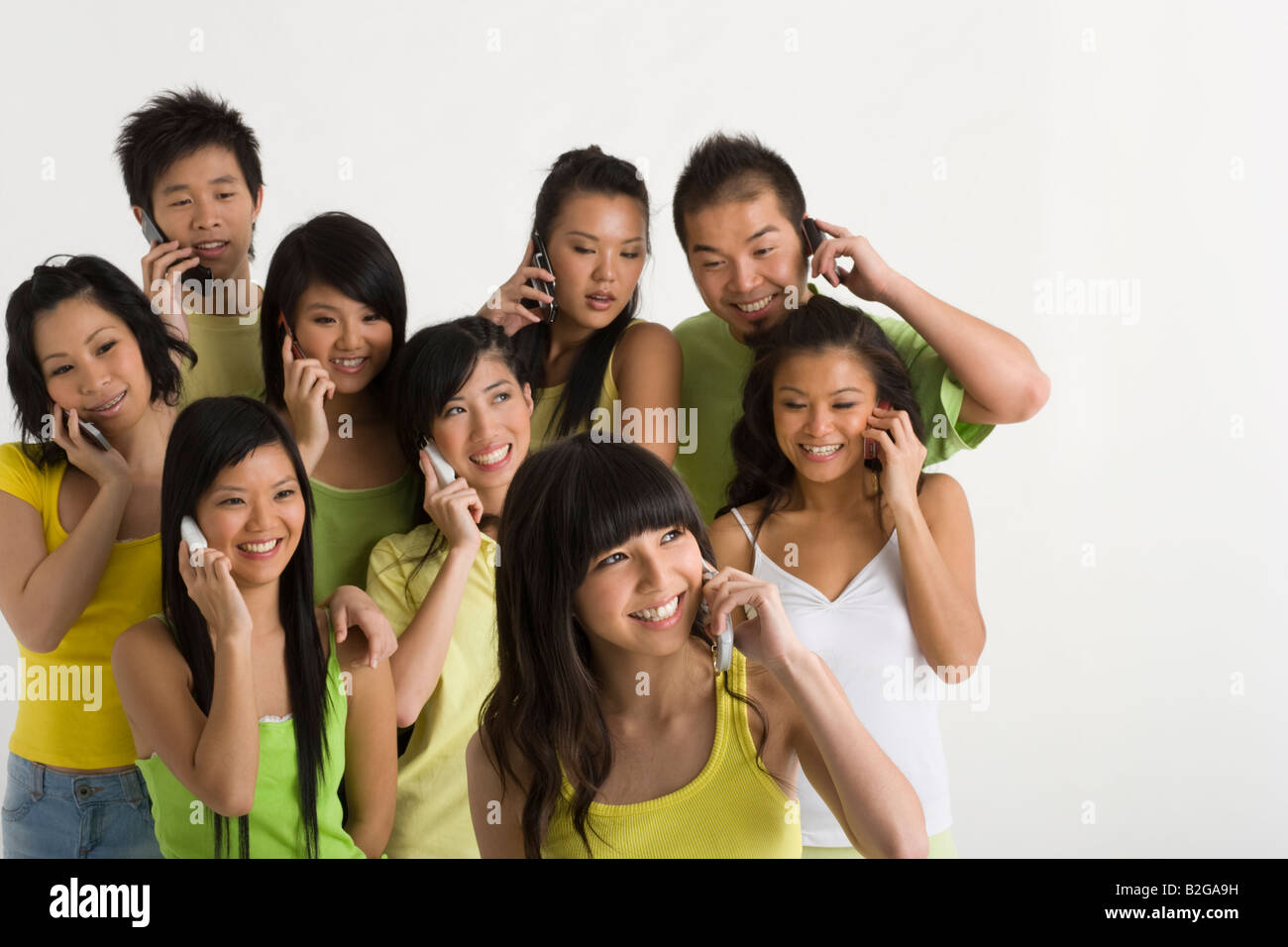 Group of friends talking on mobile phones Stock Photo - Alamy