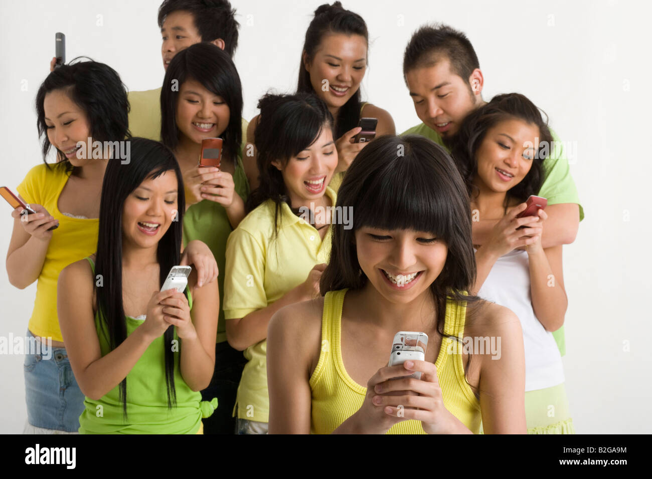 Group of friends text messaging Stock Photo - Alamy