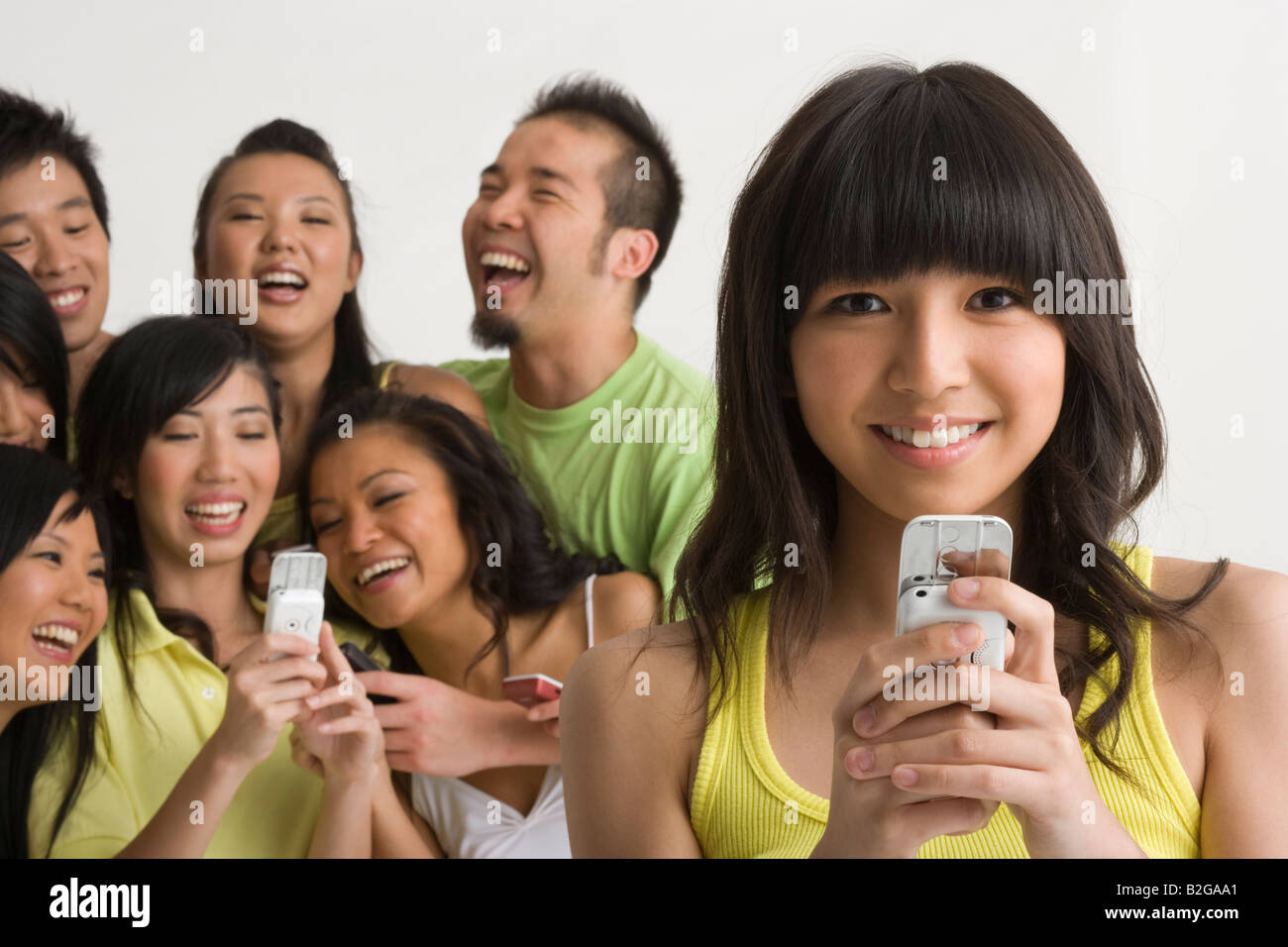 Portrait of a young woman text messaging with her friends in the ...