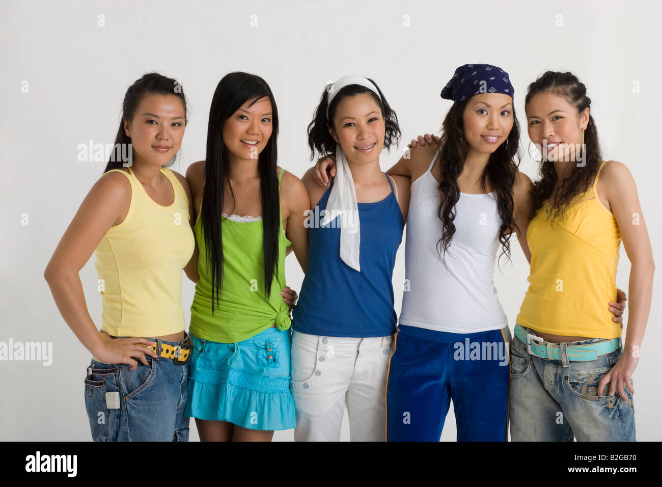 Portrait of five young women standing together and smiling Stock Photo ...