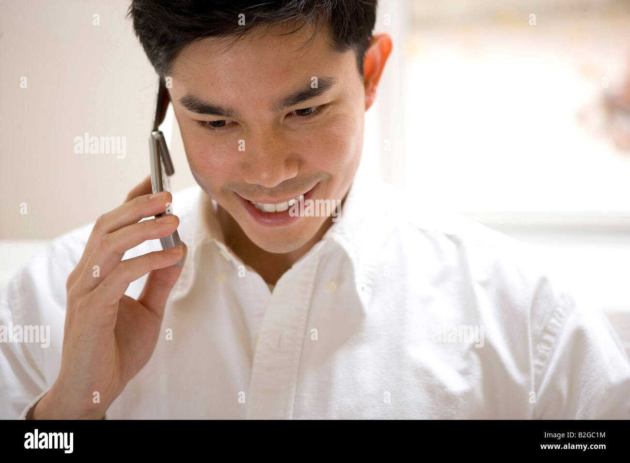 A young man using a mobile phone Stock Photo - Alamy