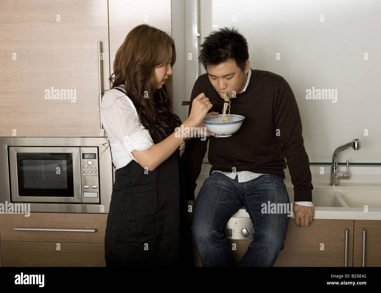 Romantic young woman feeding boyfriend High Resolution Stock ...
