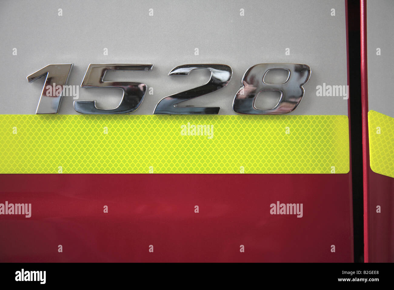 Chrome numbers on a fire engine with refective yellow band Stock Photo ...