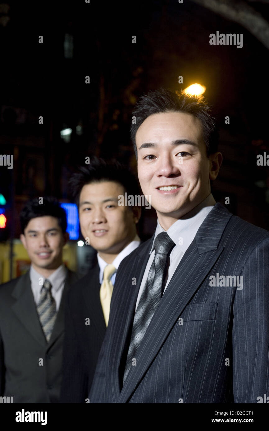 Portrait of smiling businessmen standing in a row Stock Photo - Alamy