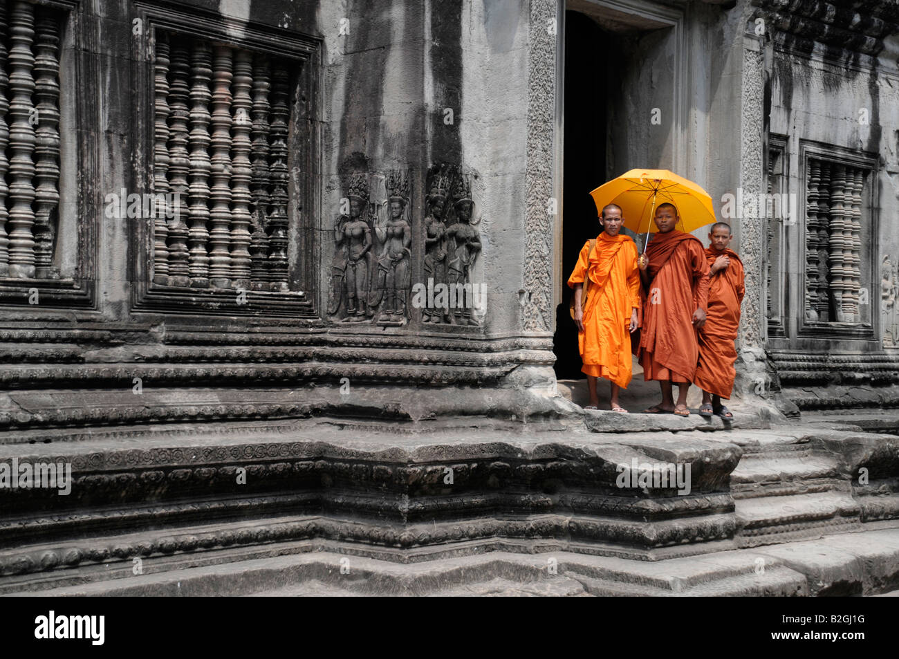 Three Monks in Angkor Wat Stock Photo - Alamy