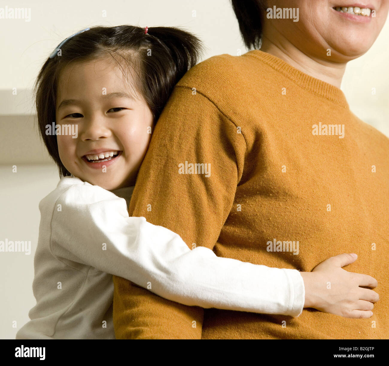 Portrait of a girl hugging her grandmother and smiling, Shanghai, China ...