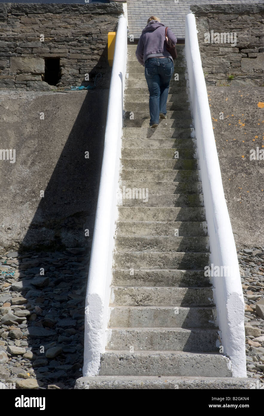 Woman walking up steep steps, Kilkee, County Clare, Ireland Stock Photo ...