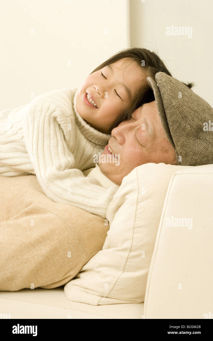 Children hugging grandfather hi-res stock photography and images - Alamy