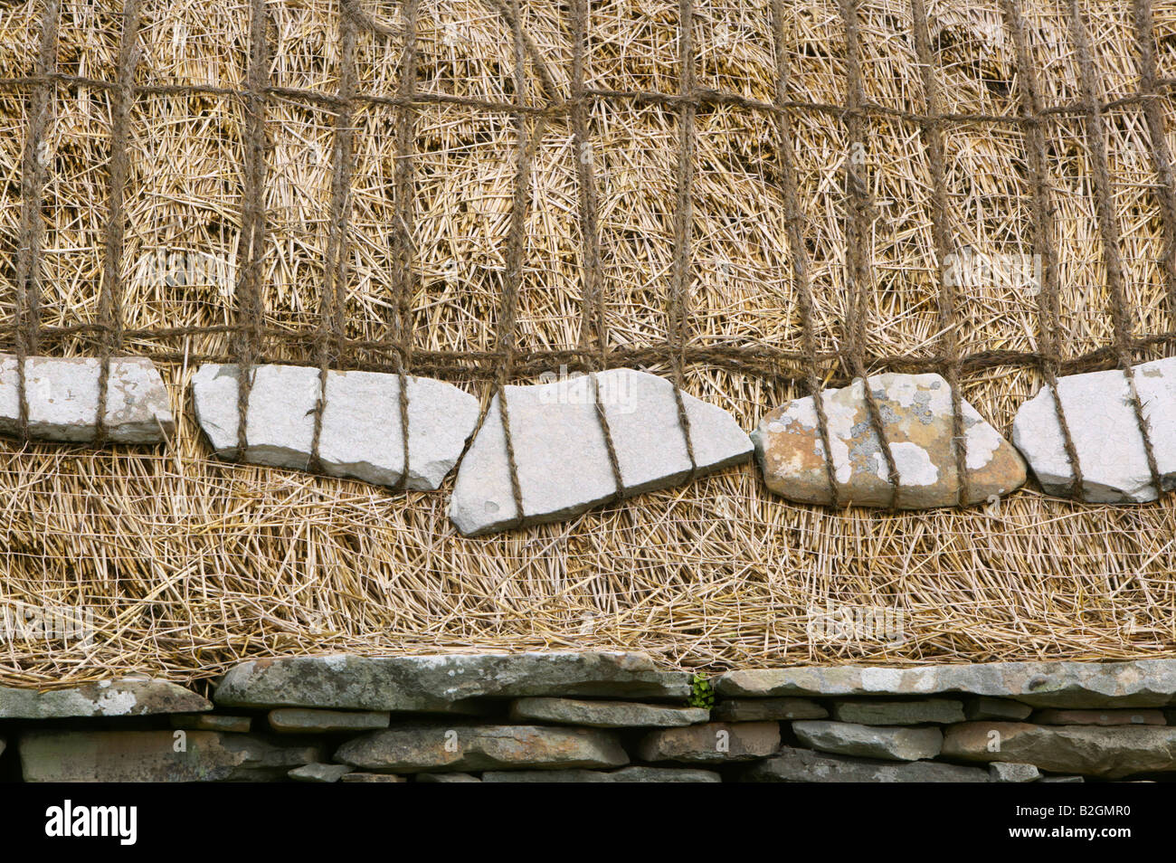 Stone weights and rope to secure the thatch on the roof of the Shetland ...