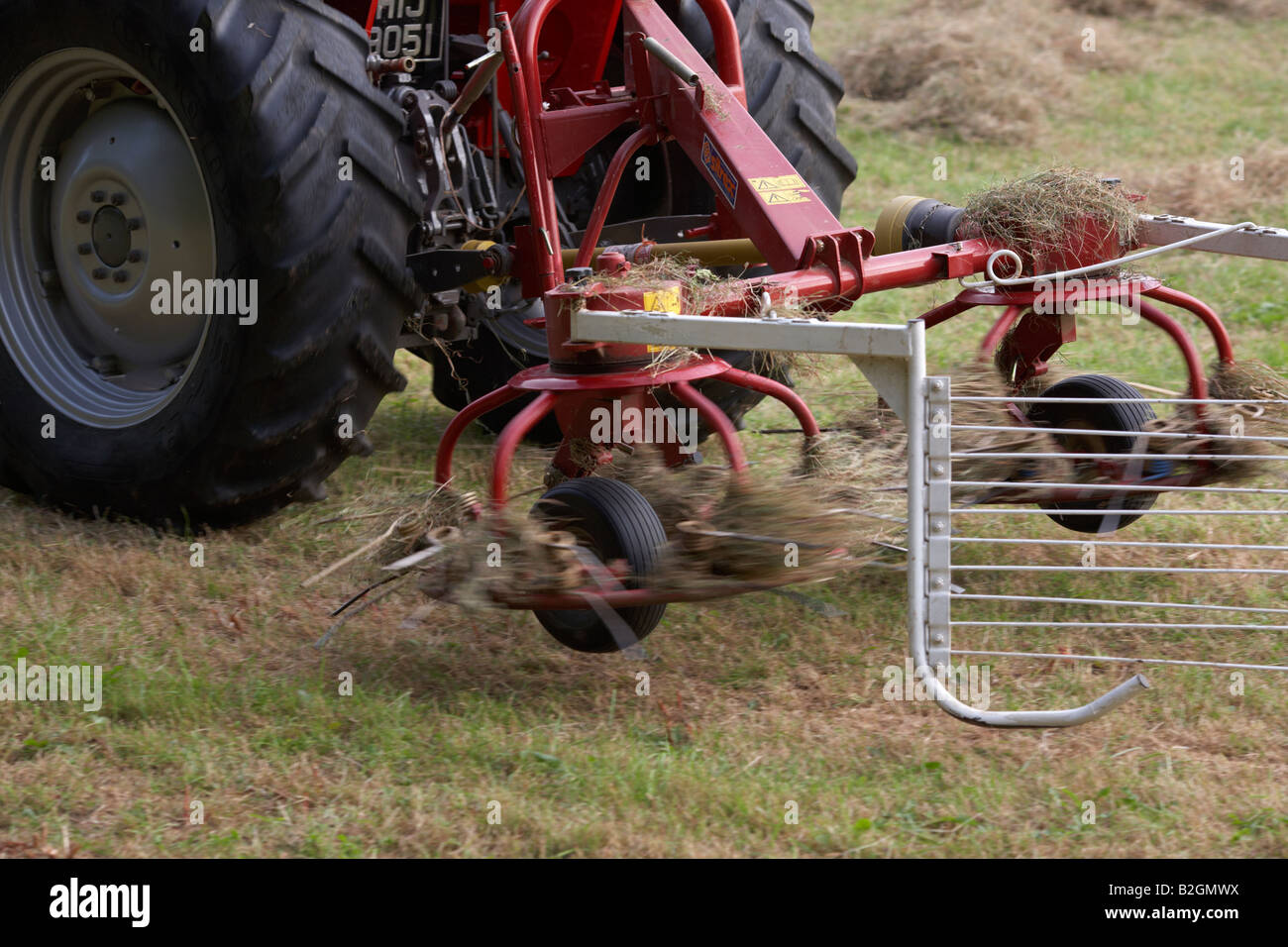 massey ferguson 185 old tractor pulling a haymaker attachment in a ...