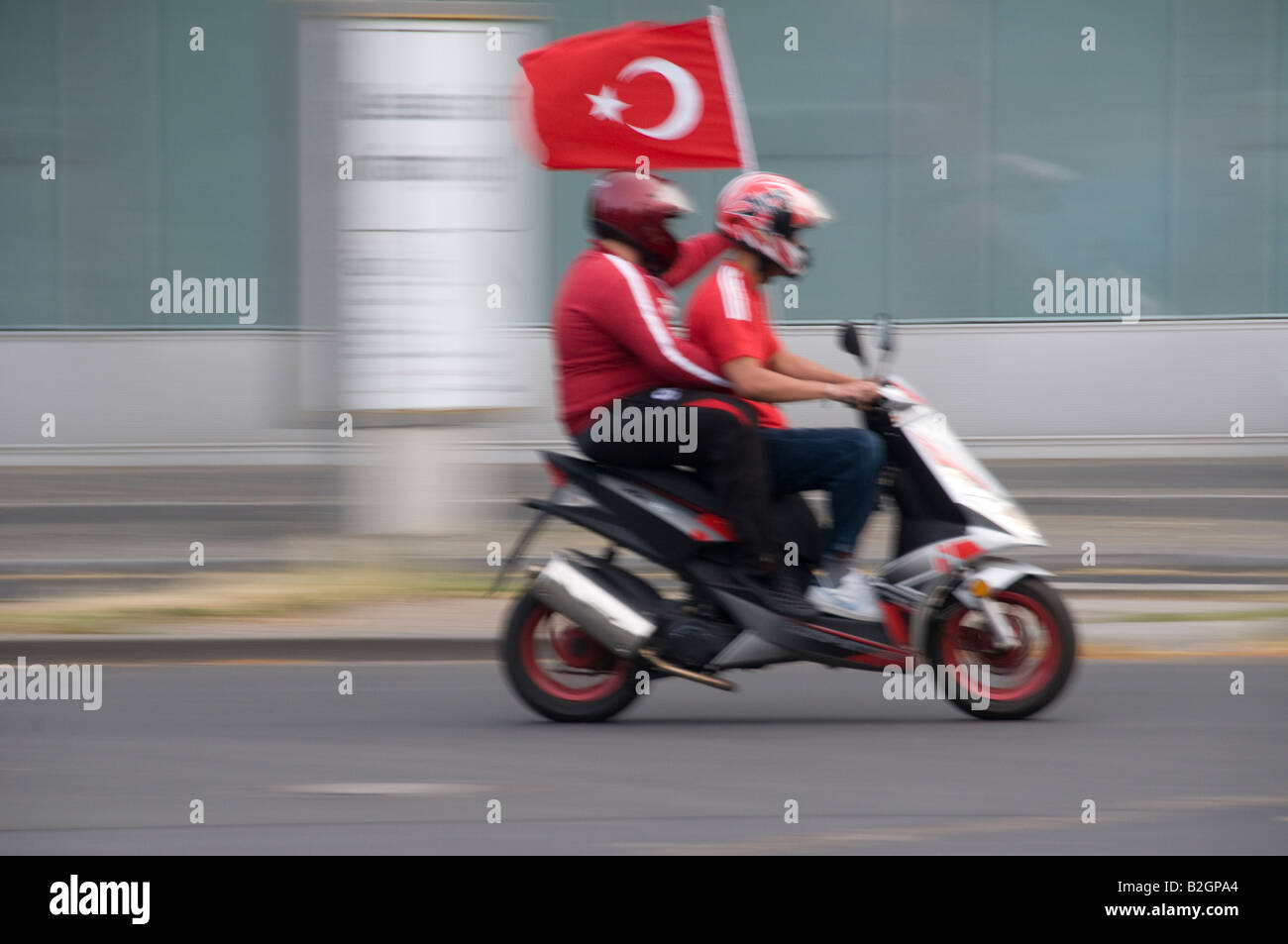 Germans with Turkish roots ride a scooter with Turkey flag during Euro ...