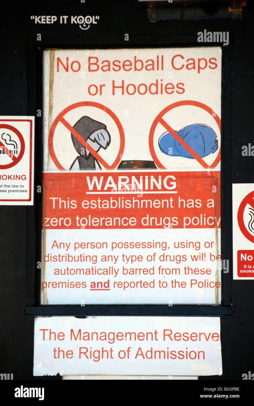 Warning sign on pub door anti hoodies drugs baseball caps Stock Photo ...