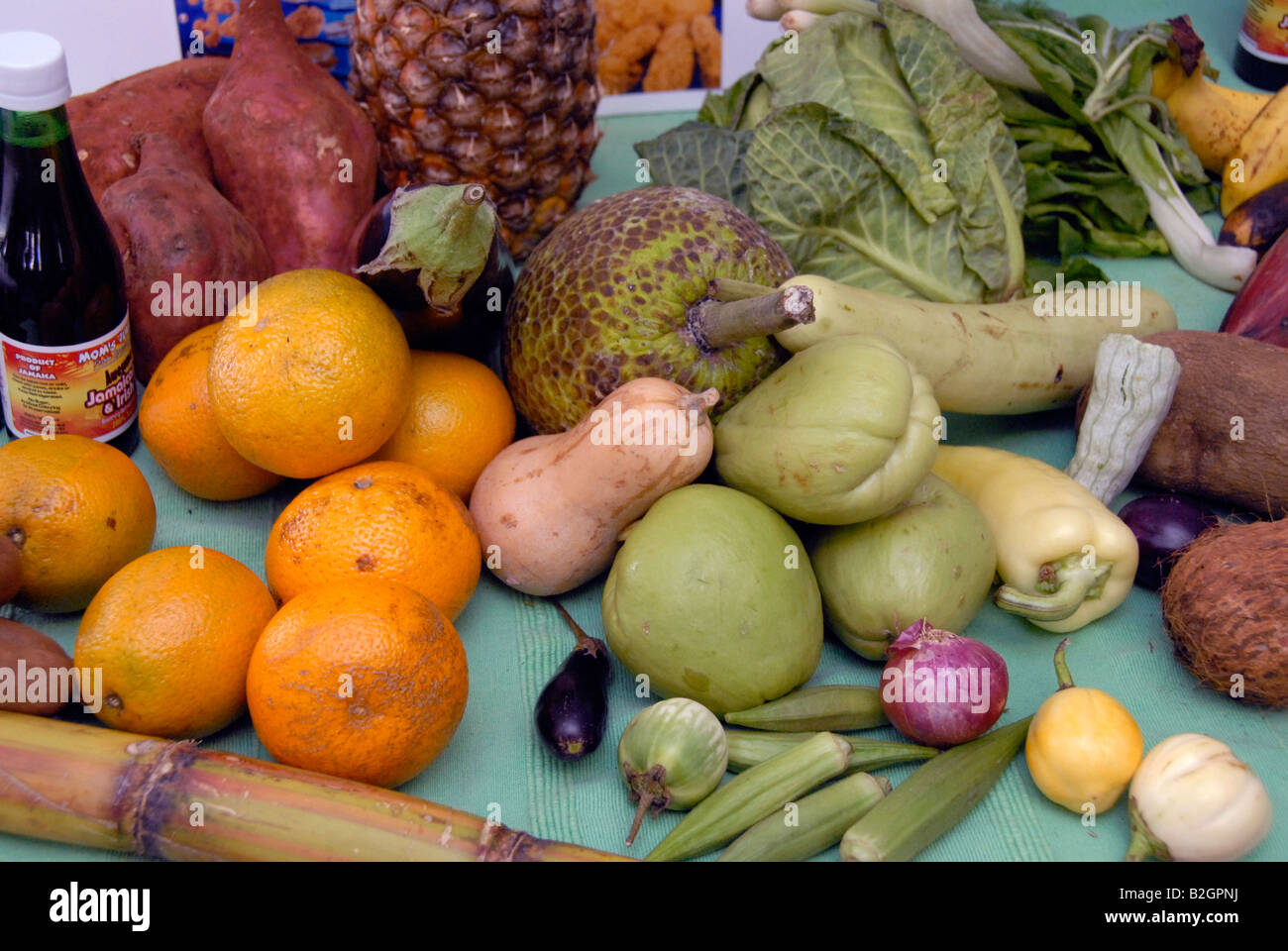 Mix of tropical Fresh fruit and vegetables on display Stock Photo - Alamy